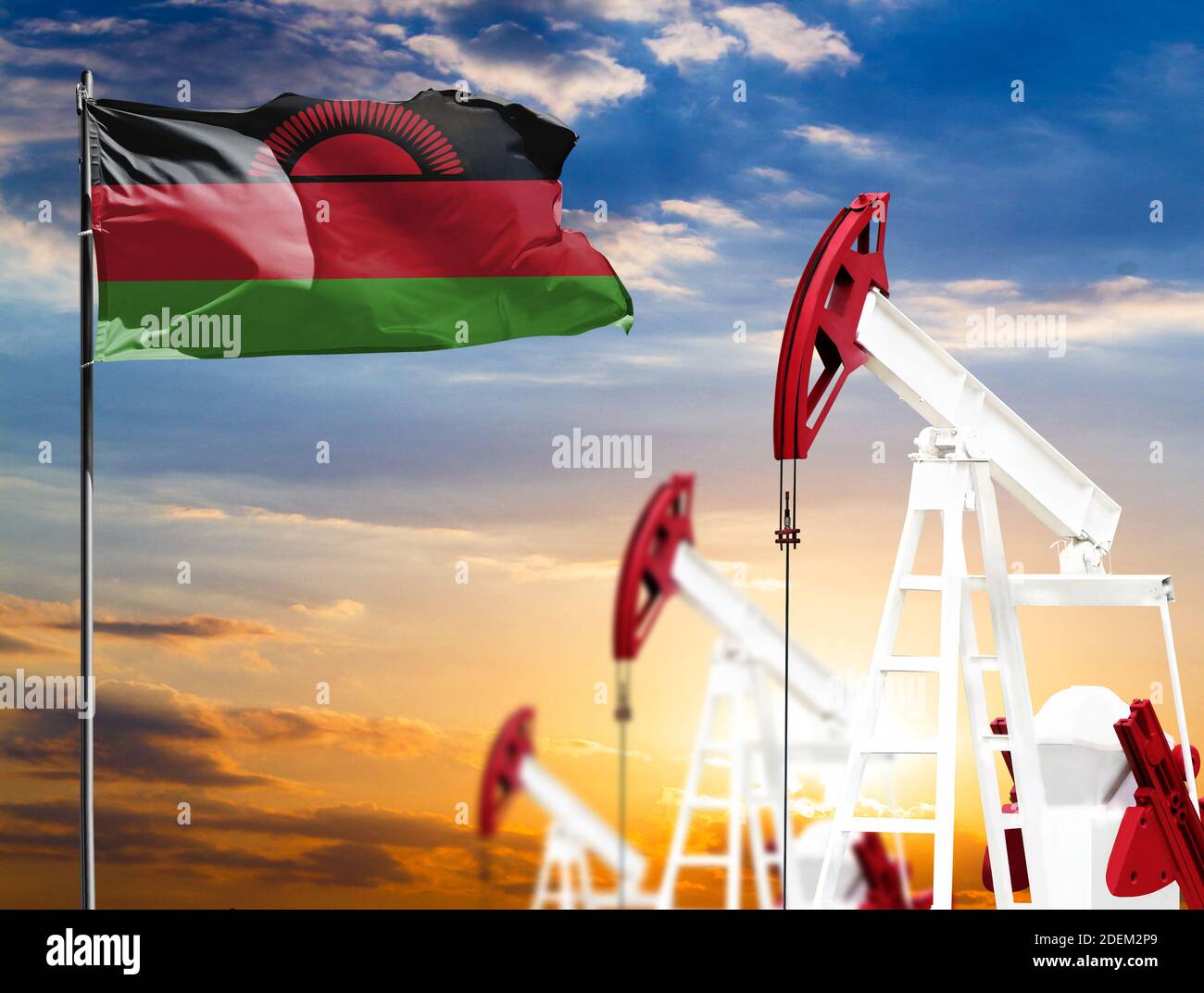 Oil rigs against the backdrop of the colorful sky and a flagpole with ...