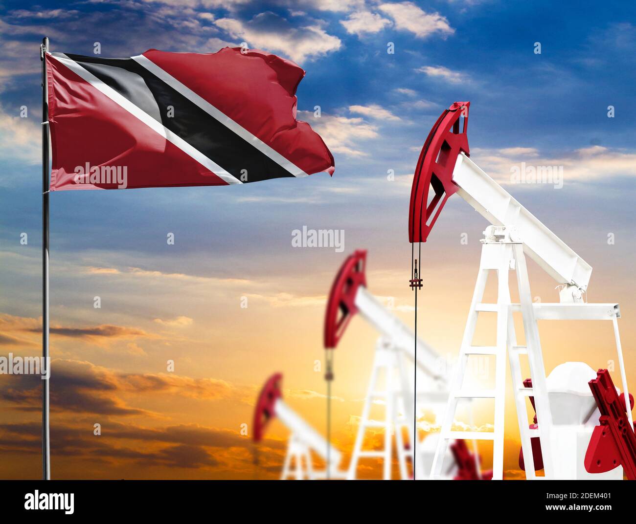 Oil rigs against the backdrop of the colorful sky and a flagpole with ...