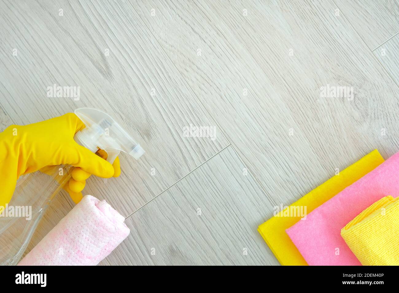 Pink cleaning tools: rags, sponges, detergent liquid, hands in rubber ...
