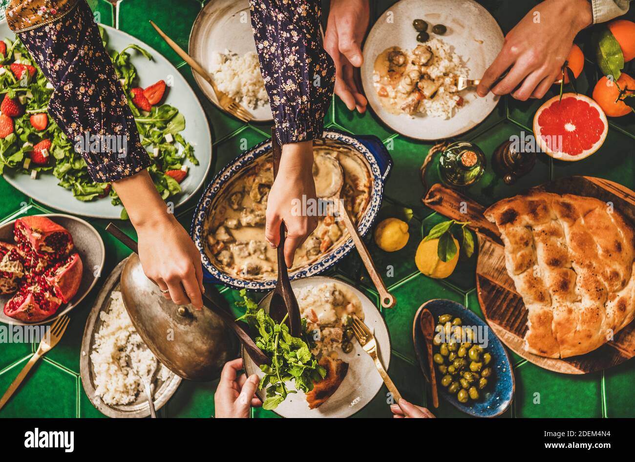 Family having Turkish dinner. Flat-lay of people hands taking lamb in ...