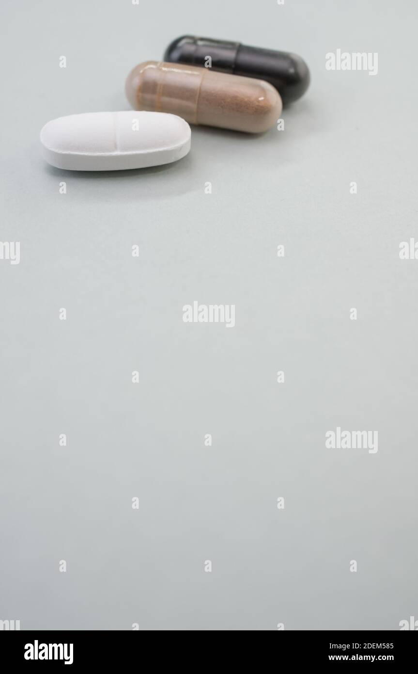 A closeup shot of capsules isolated on gray background Stock Photo - Alamy