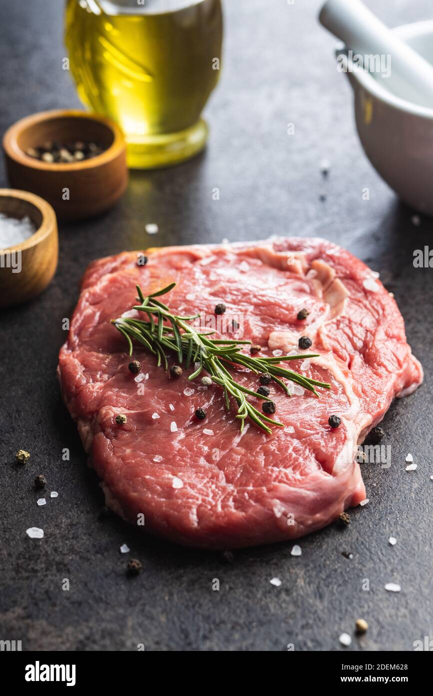 Sliced raw ribeye steak on a black kitchen table Stock Photo - Alamy