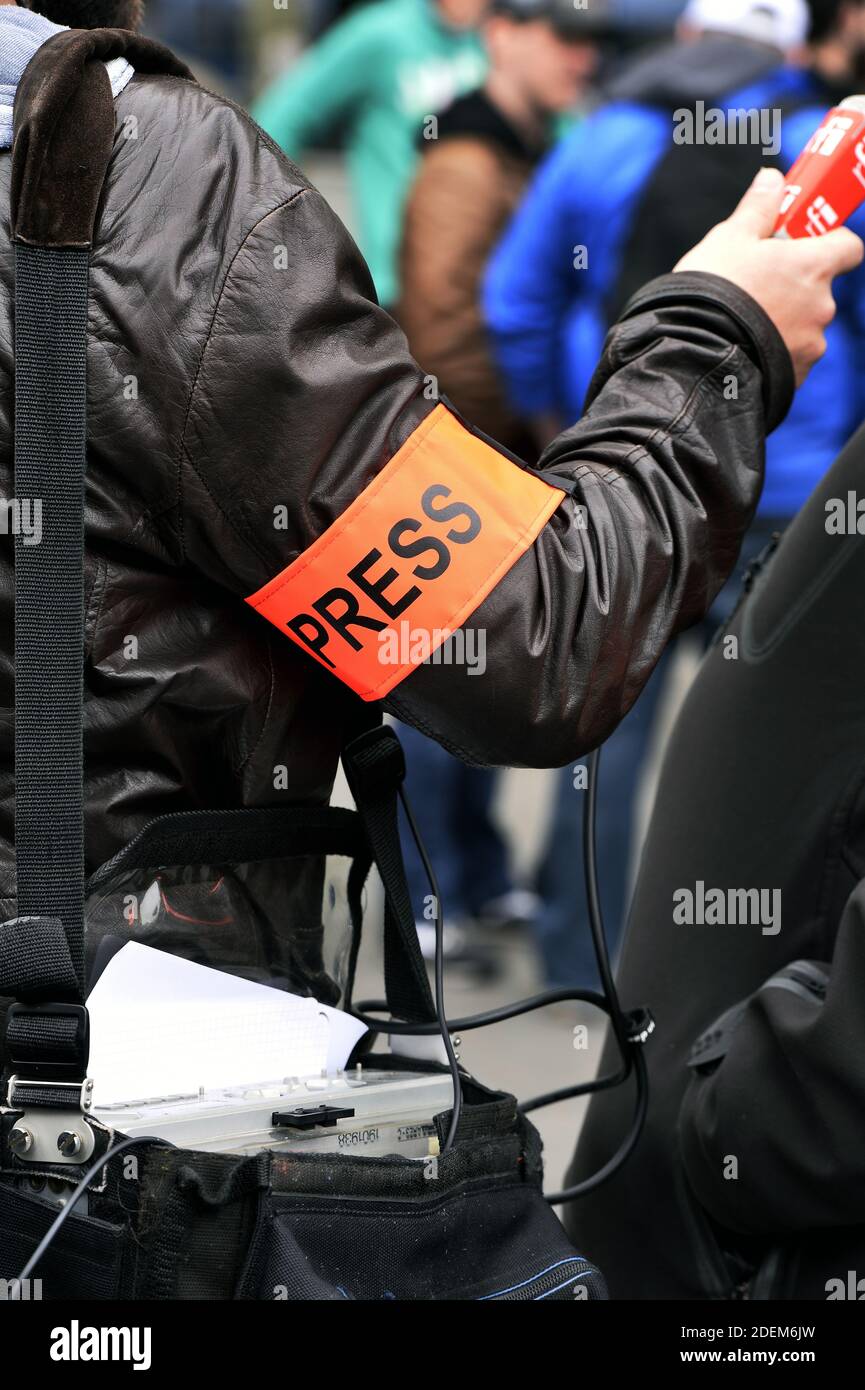 Journalist Reporter wearing a press harmband in interview during a ...
