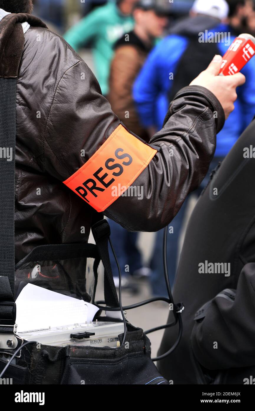 Journalist Reporter wearing a press harmband in interview during a ...