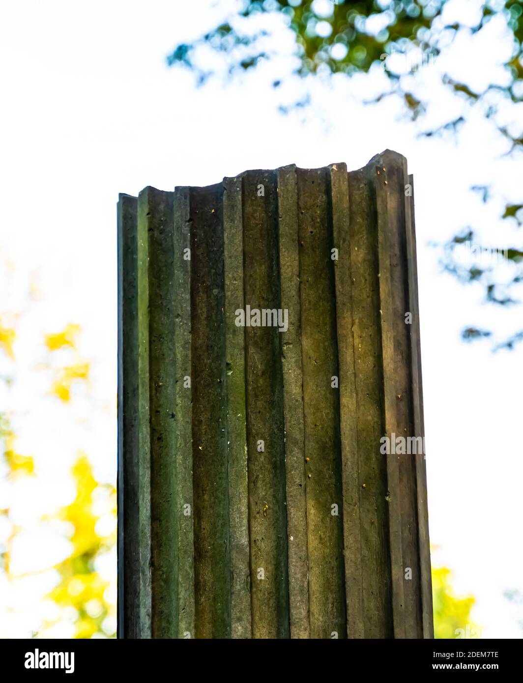 Broken old Greek stone pillar in a park. Symbol of power and authority ...