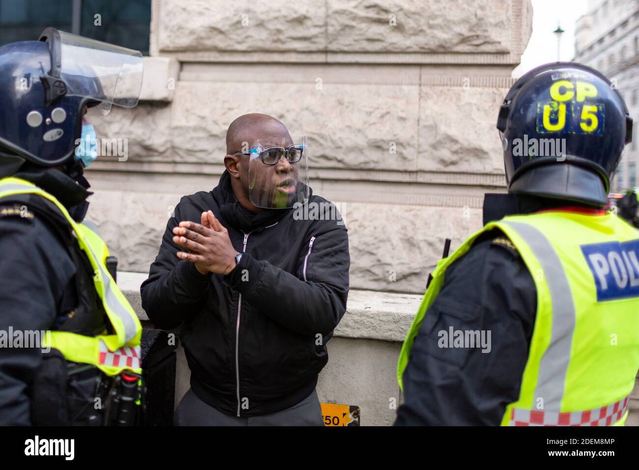 Anti-lockdown protest, London, 28 November 2020. A black man wearing a ...