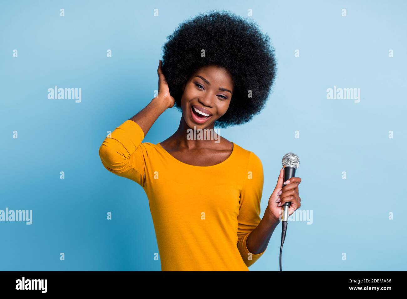 Photo portrait of pretty black skinned girl keeping microphone smiling ...