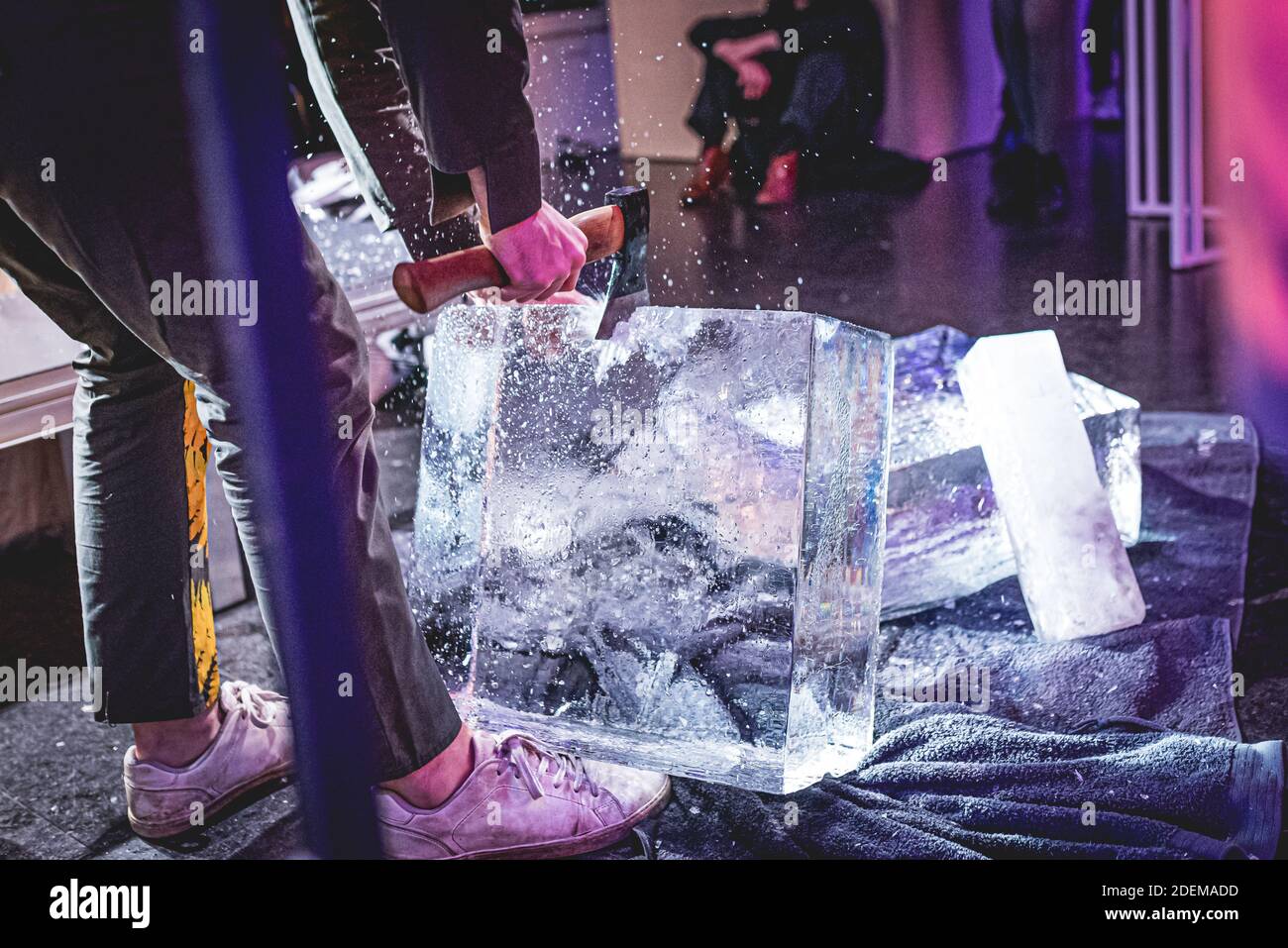 Large ice cubes being broken with hammer Stock Photo - Alamy
