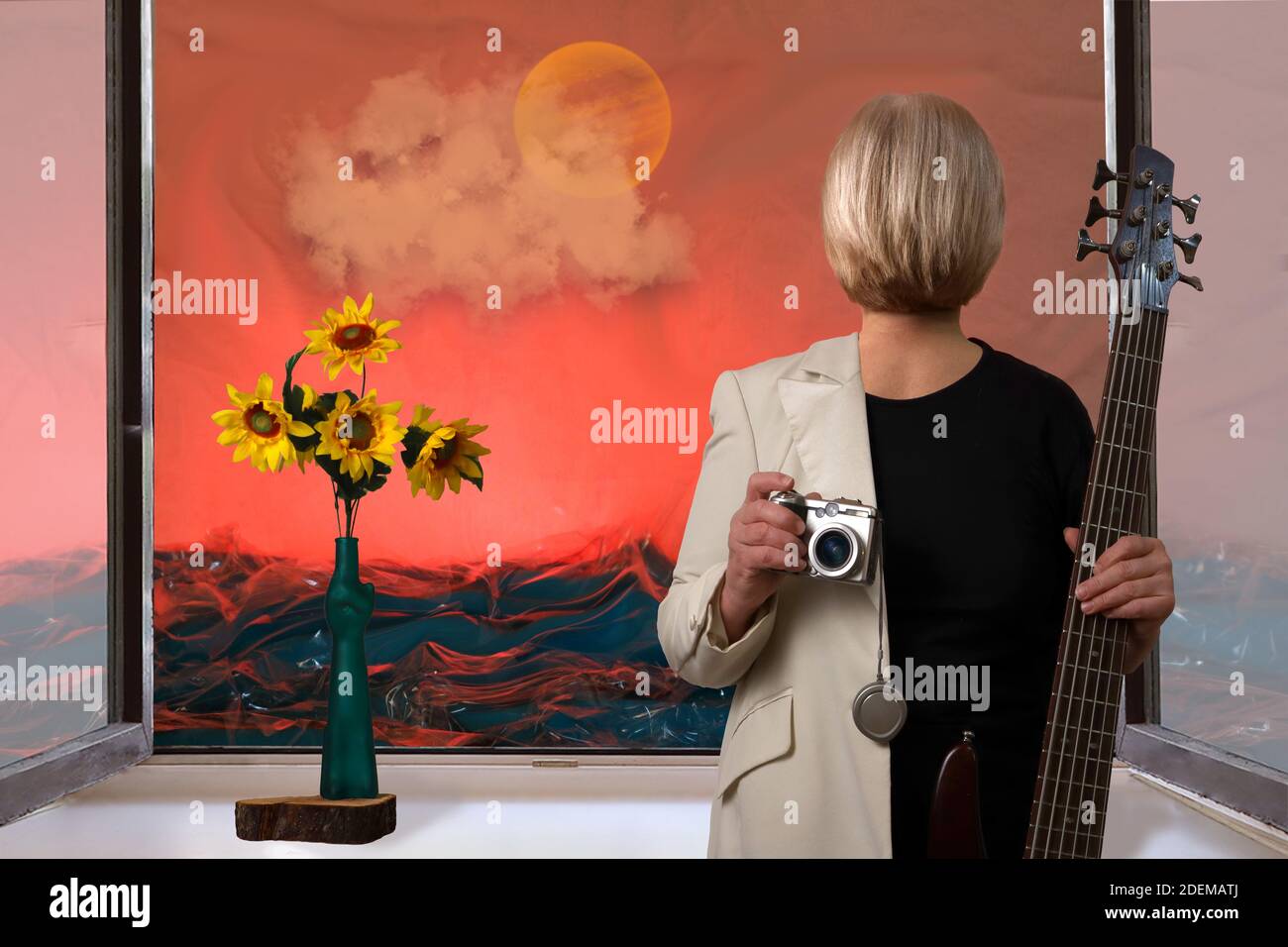 A human figure dressed in black and white with bass guitar and photo ...