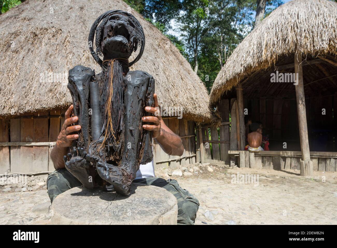 Villager showing the mummy of a former Dani chief in his village ...