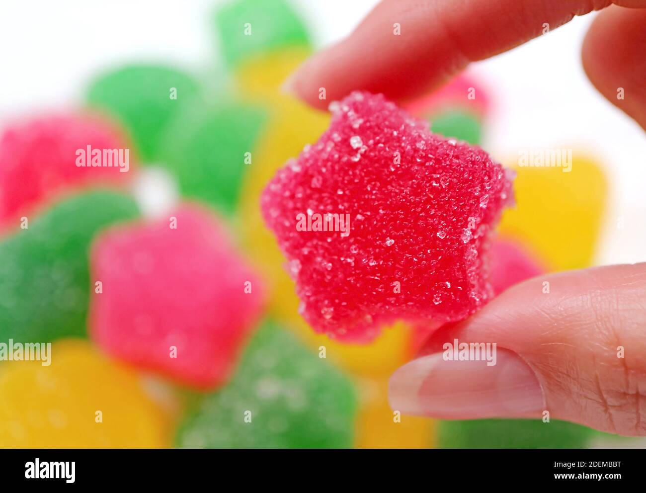 Woman's Hand Picking Vibrant Hot Pink Sugar Coated Fruity Flavored Soft ...