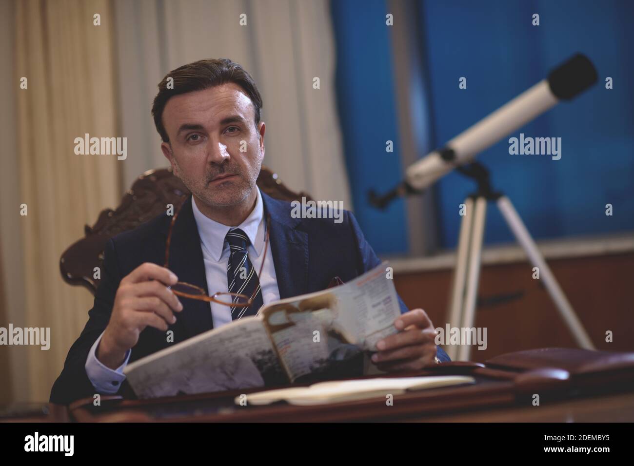 corporate business man at office reading magazine Stock Photo - Alamy