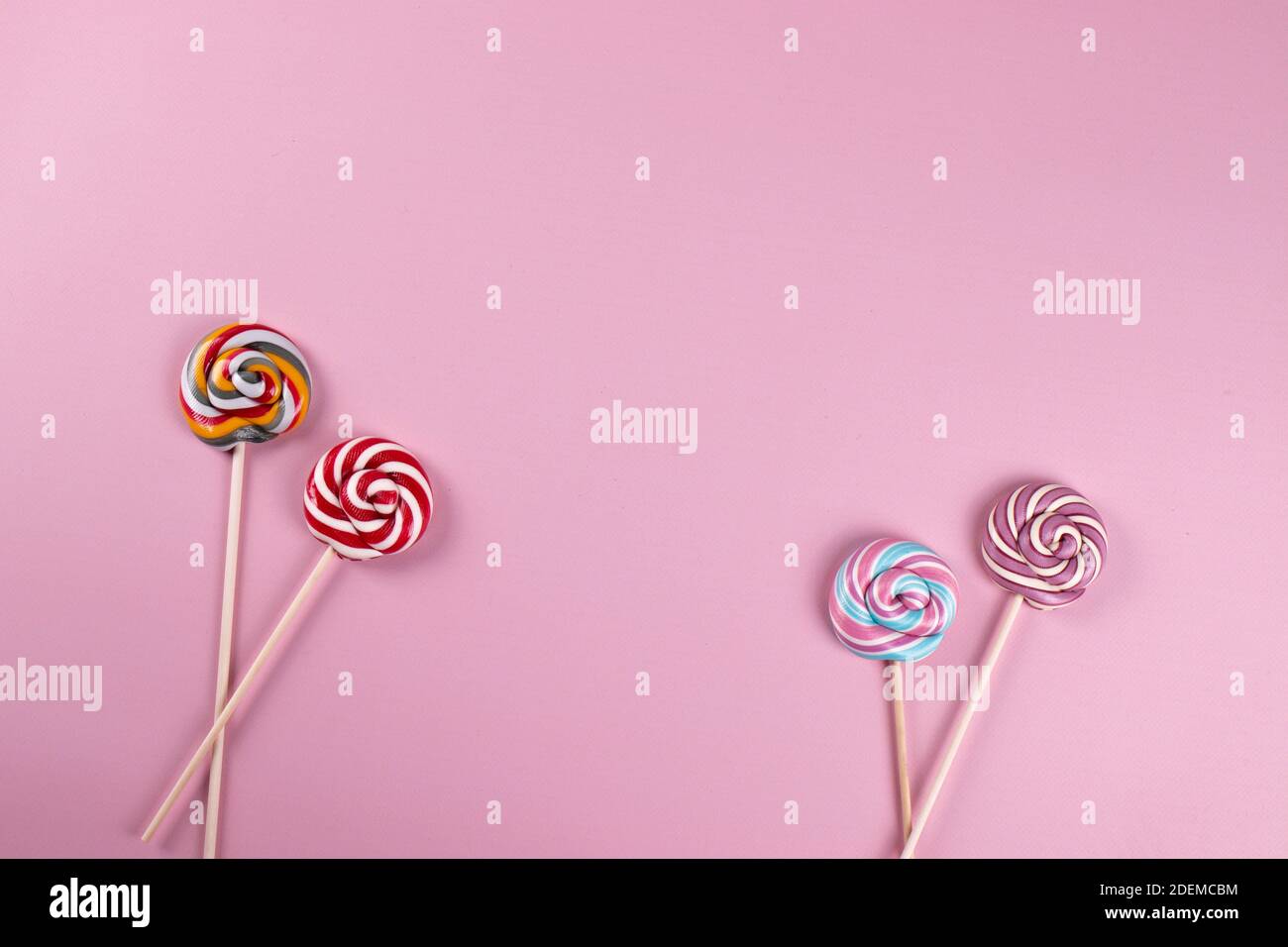 sweet yummy festive colorful lollipops on light blue background. copy ...