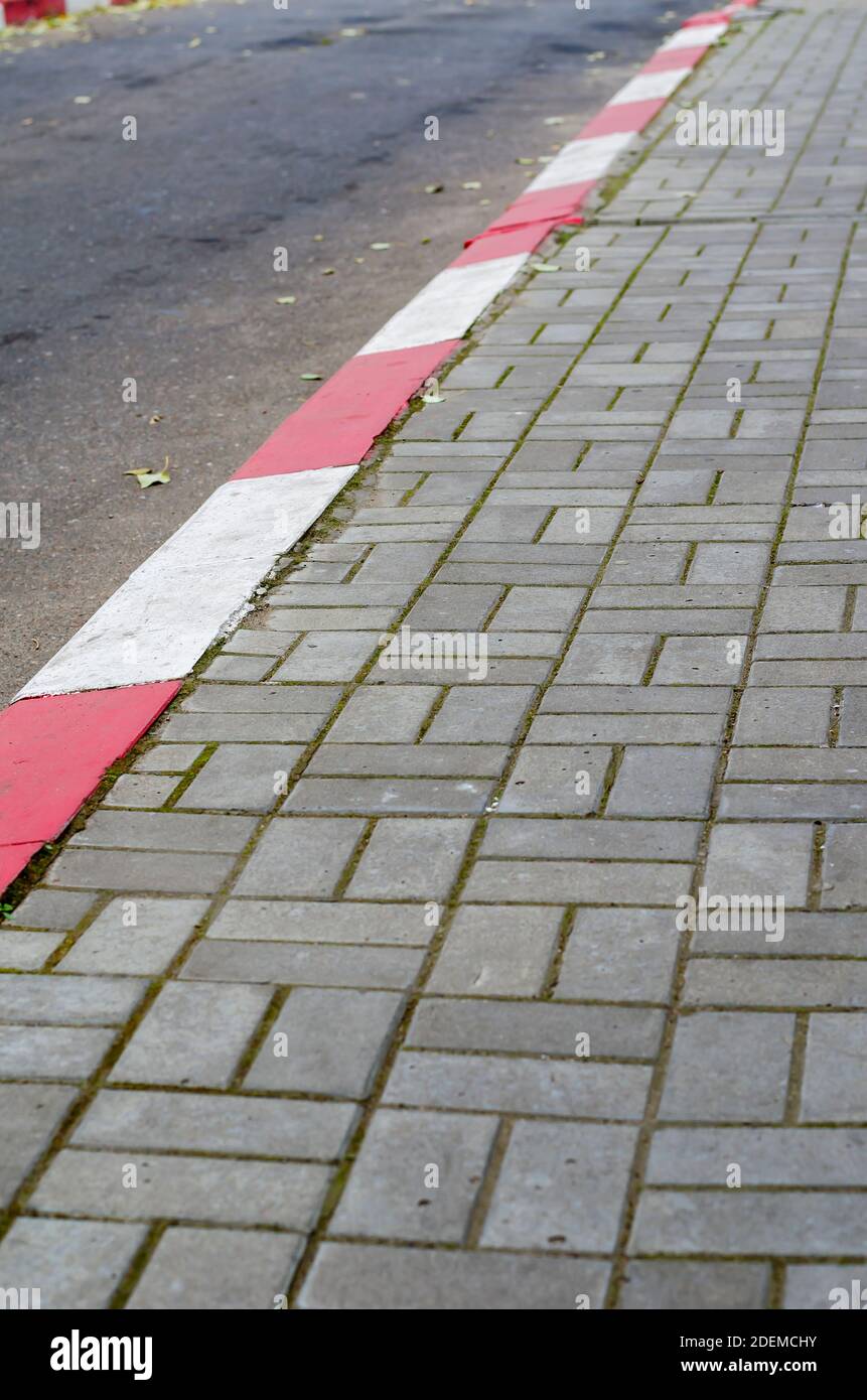 White-red line on the road edge. White and red strip no parking sign on ...