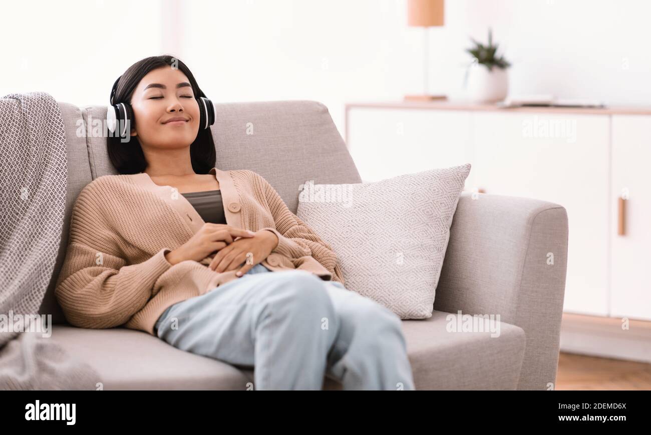 Asian woman listening music using hi-res stock photography and images ...