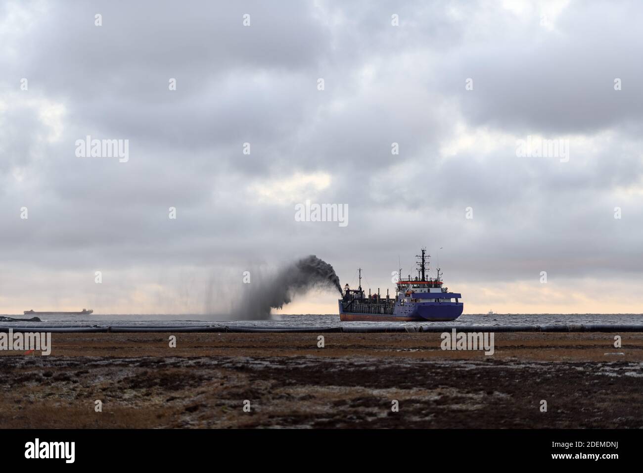 Vessel engaged in dredging. Dredger working at sea. Ship excavating ...