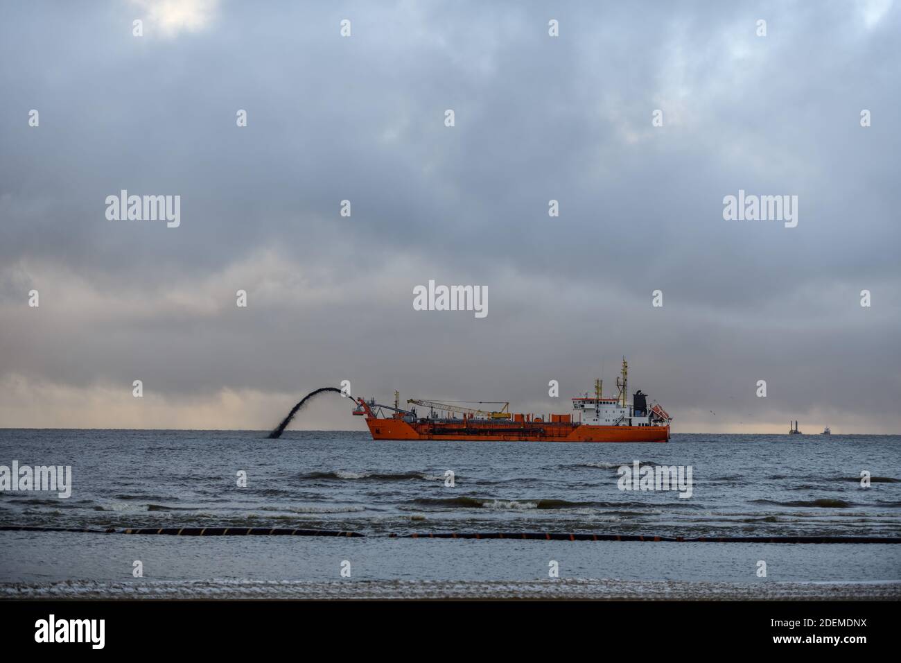 Vessel engaged in dredging. Dredger working at sea. Ship excavating ...