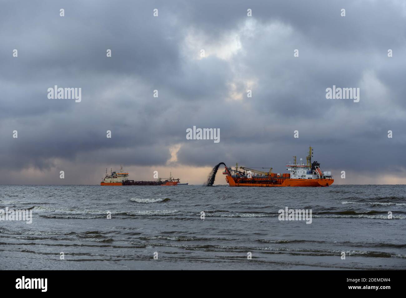 Vessel engaged in dredging. Dredger working at sea. Ship excavating ...