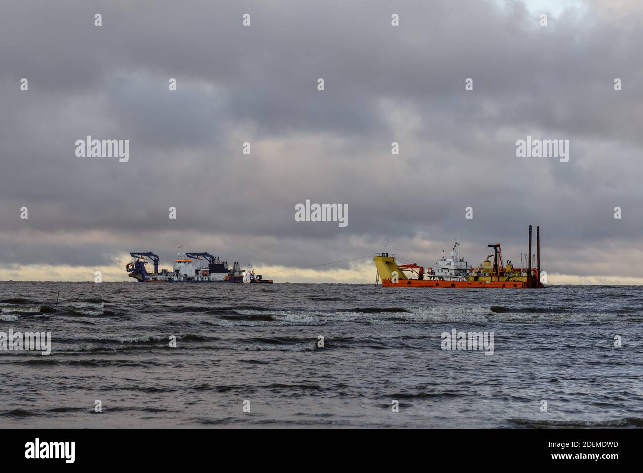 Vessel engaged in dredging. Dredger working at sea. Ship excavating ...