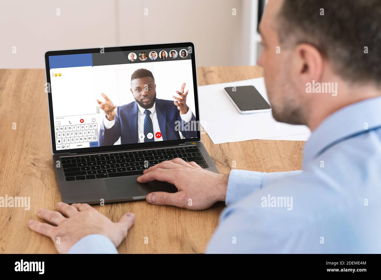 Man having online training with business coach, listening and typing ...