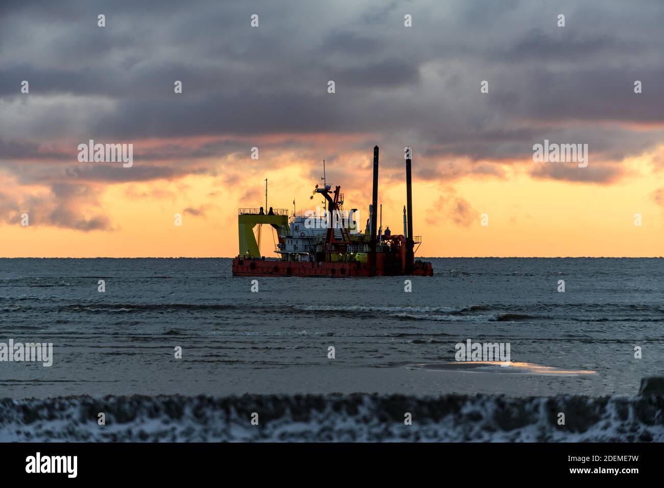 Vessel engaged in dredging. Dredger working at sea. Ship excavating ...
