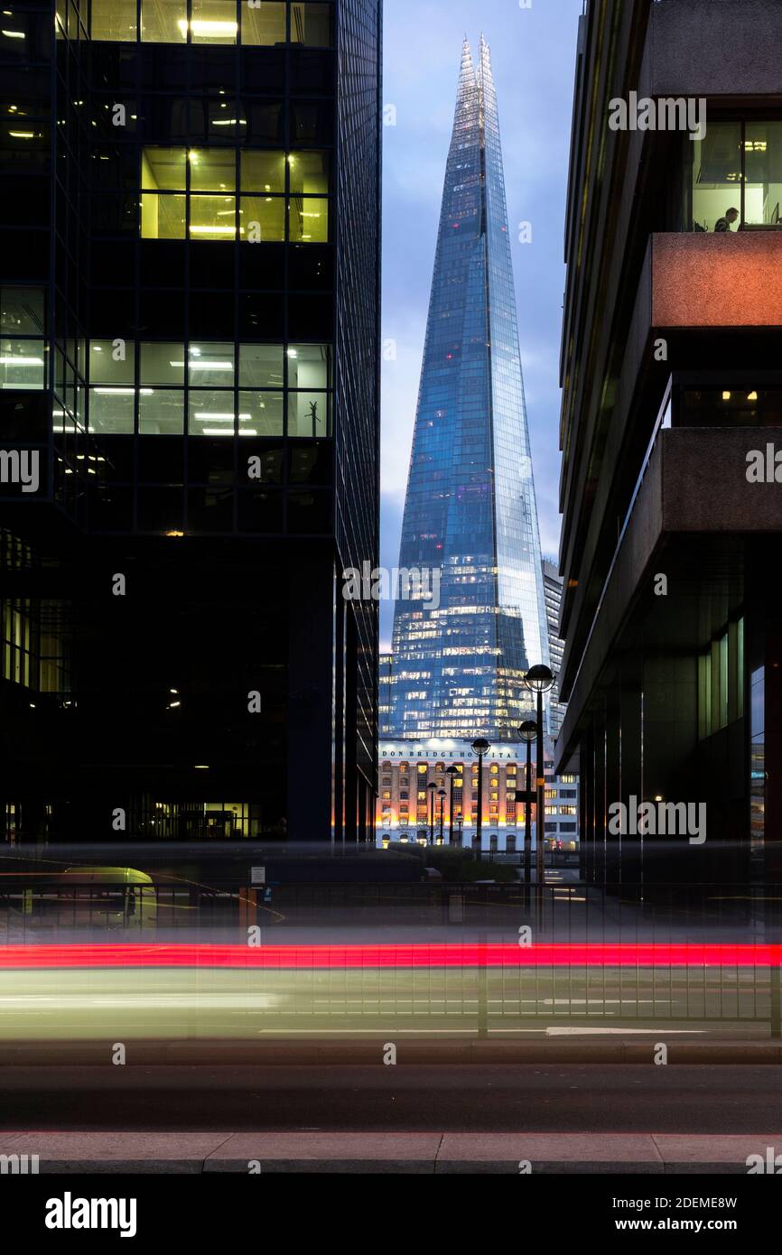 View of The Shard between illuminated tower blocks at twilight, as seen ...