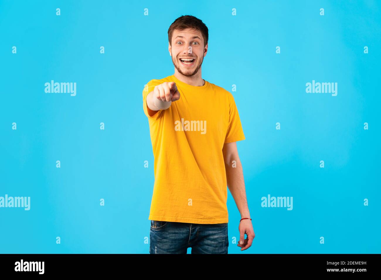 Happy male pointing finger at camera at studio Stock Photo - Alamy