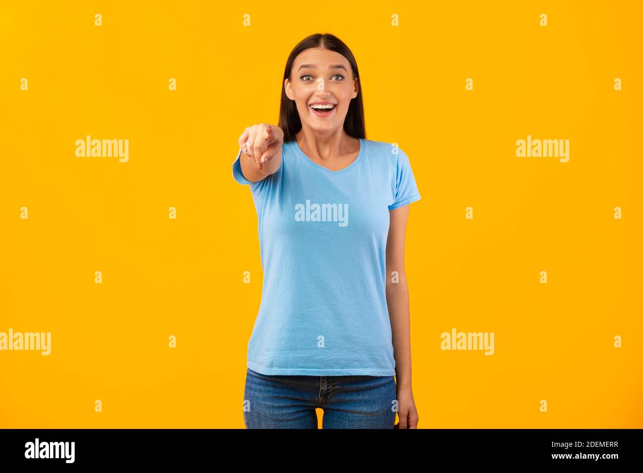 Surprised lady pointing finger at camera at studio Stock Photo - Alamy