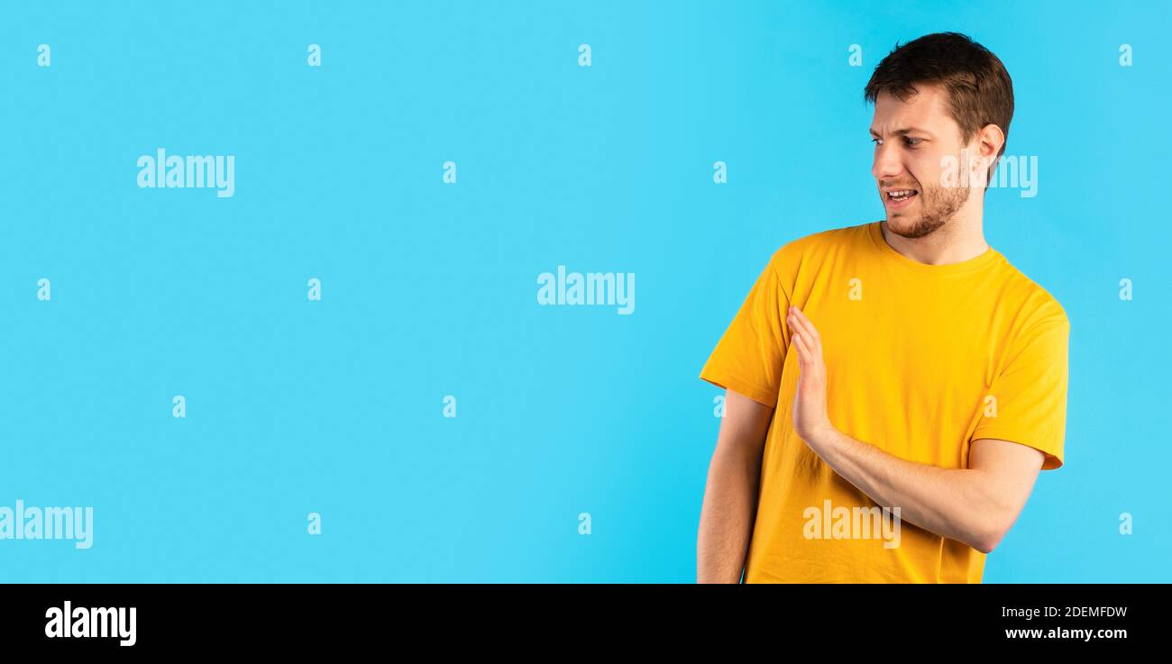 Shocked guy with disgusted face showing stop sign Stock Photo - Alamy