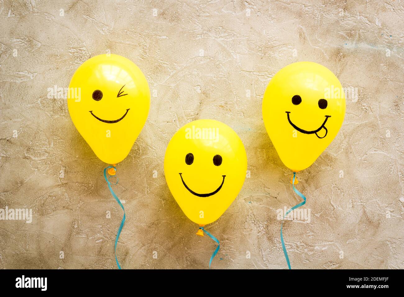 Positive emotions set. Happy and winking emoticons painted on colored ...