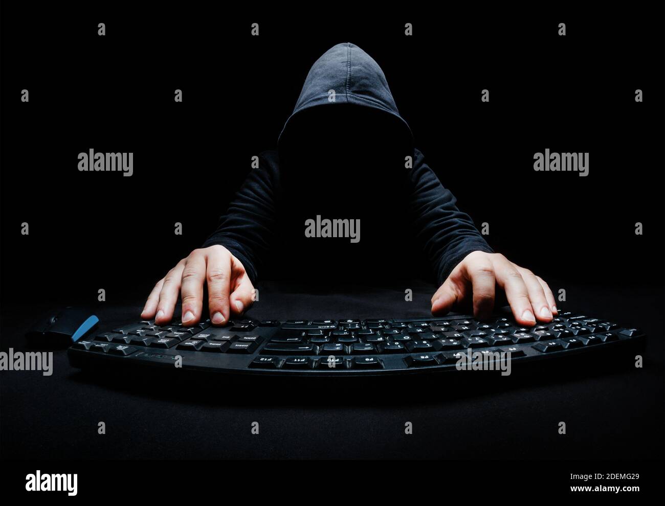 Photo Of A Shaded Evil Hacker Theaf In Black Hoodie Typing On Keyboard