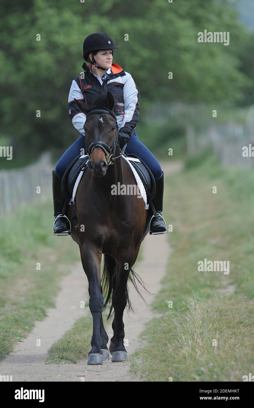 A Woman riding a horse out in the countryside Stock Photo - Alamy