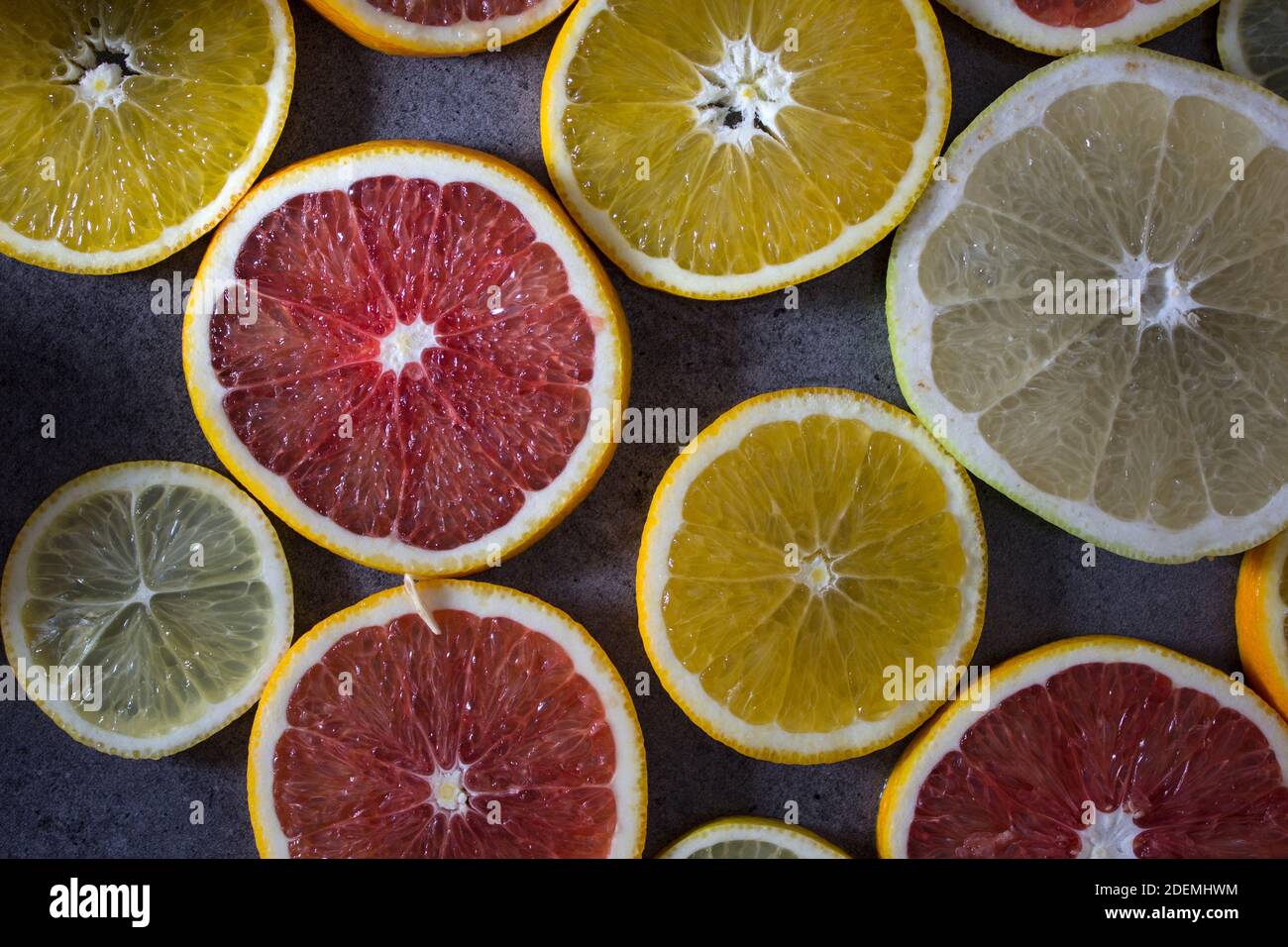 Red orange slices on a table. Fruit texture close up photo. Dark gray ...