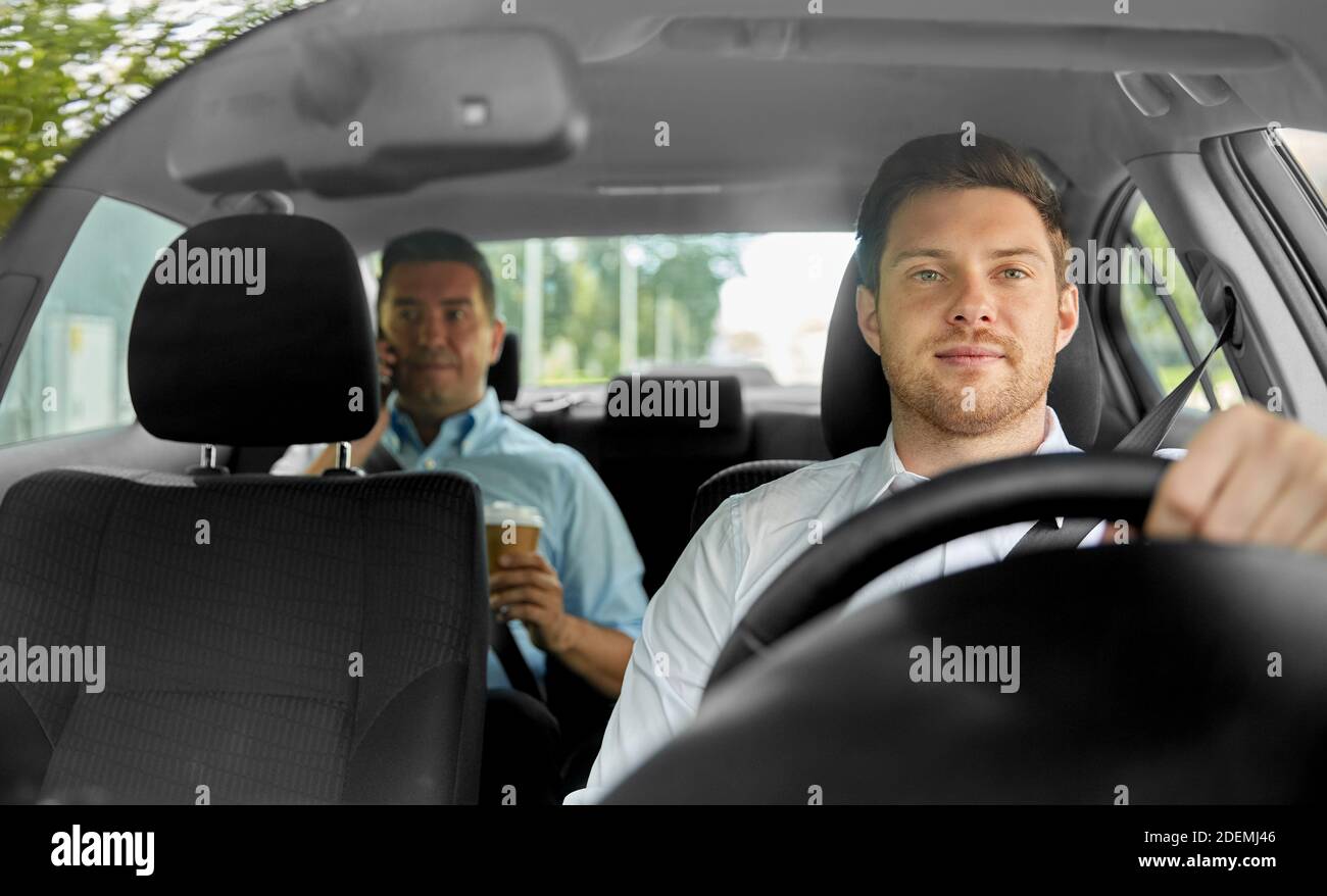 male taxi driver driving car with passenger Stock Photo - Alamy