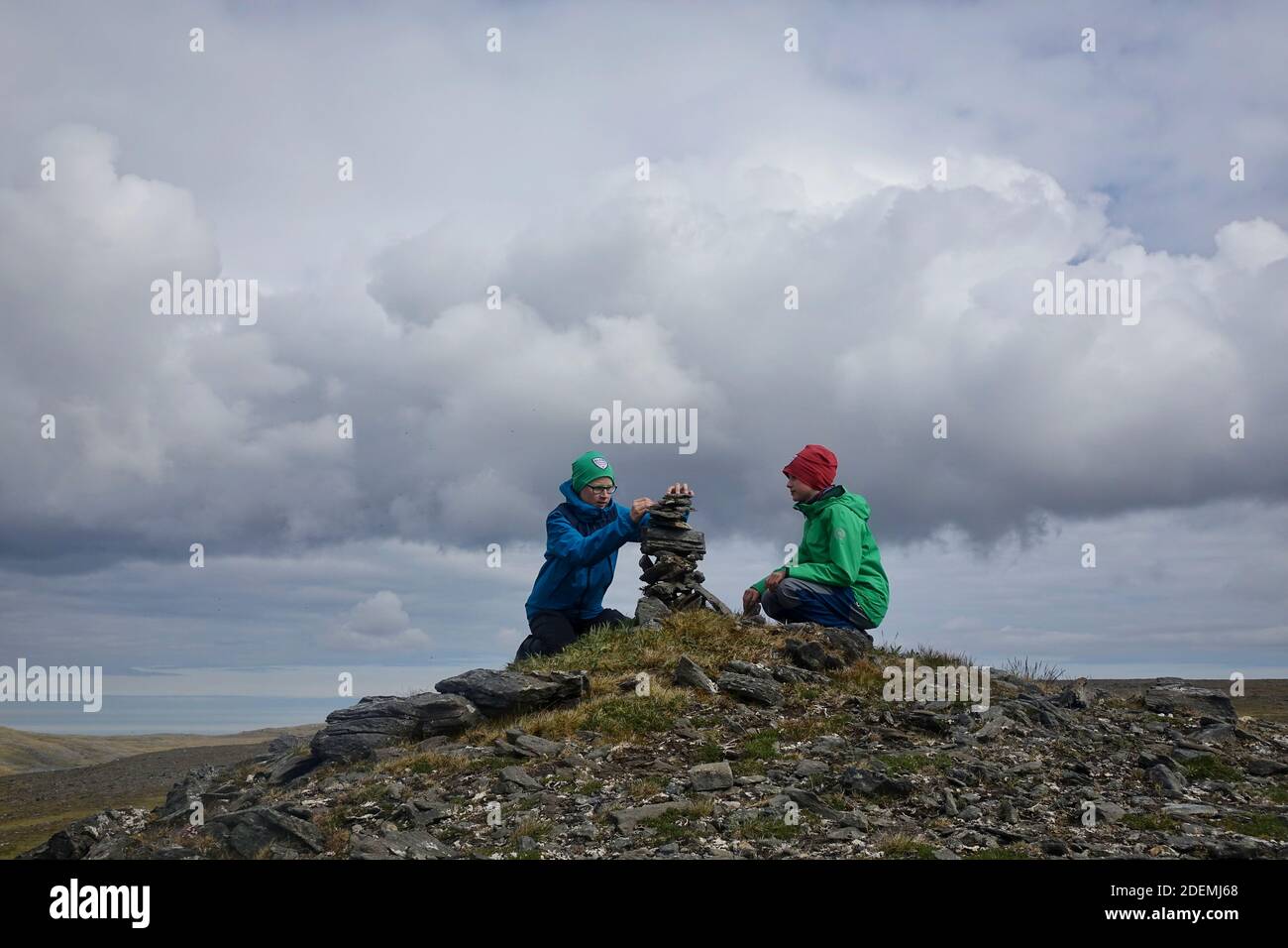 two young boys marking trial with stone crain Stock Photo - Alamy