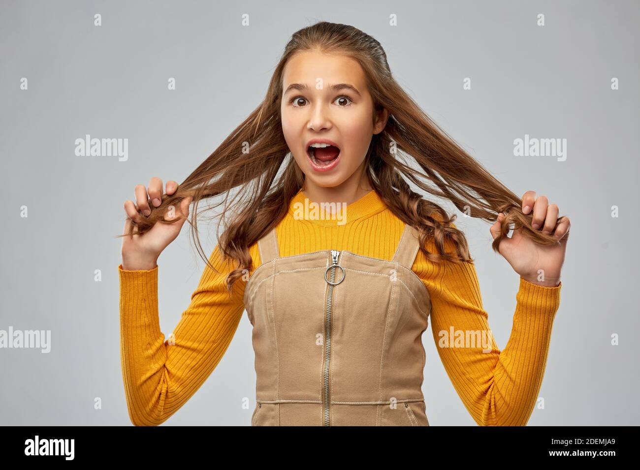 scared young teenage girl holding her hair strands Stock Photo - Alamy