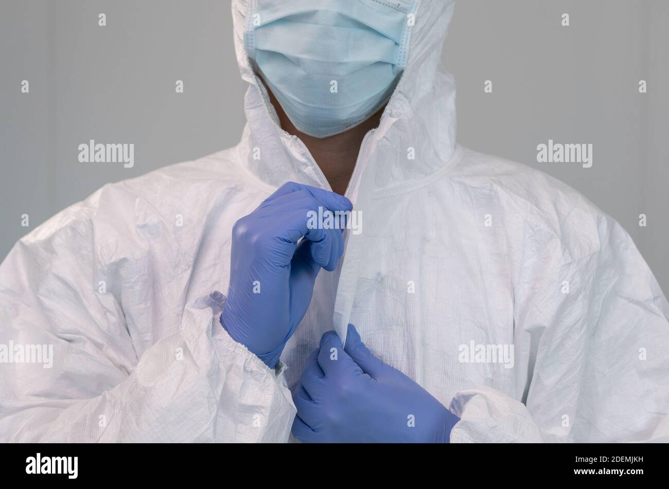 A nurse prepares by putting on protective suit during coronavirus ...