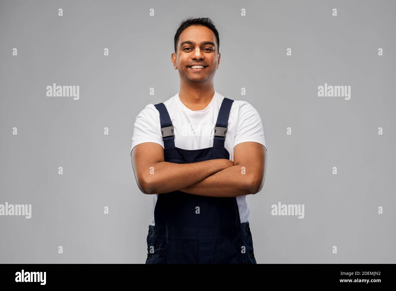 happy indian worker or builder with crossed arms Stock Photo - Alamy