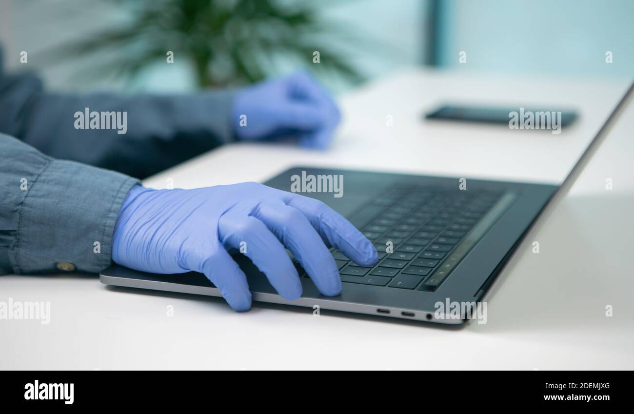 Computer keyboard hands gloves typing hi-res stock photography and ...