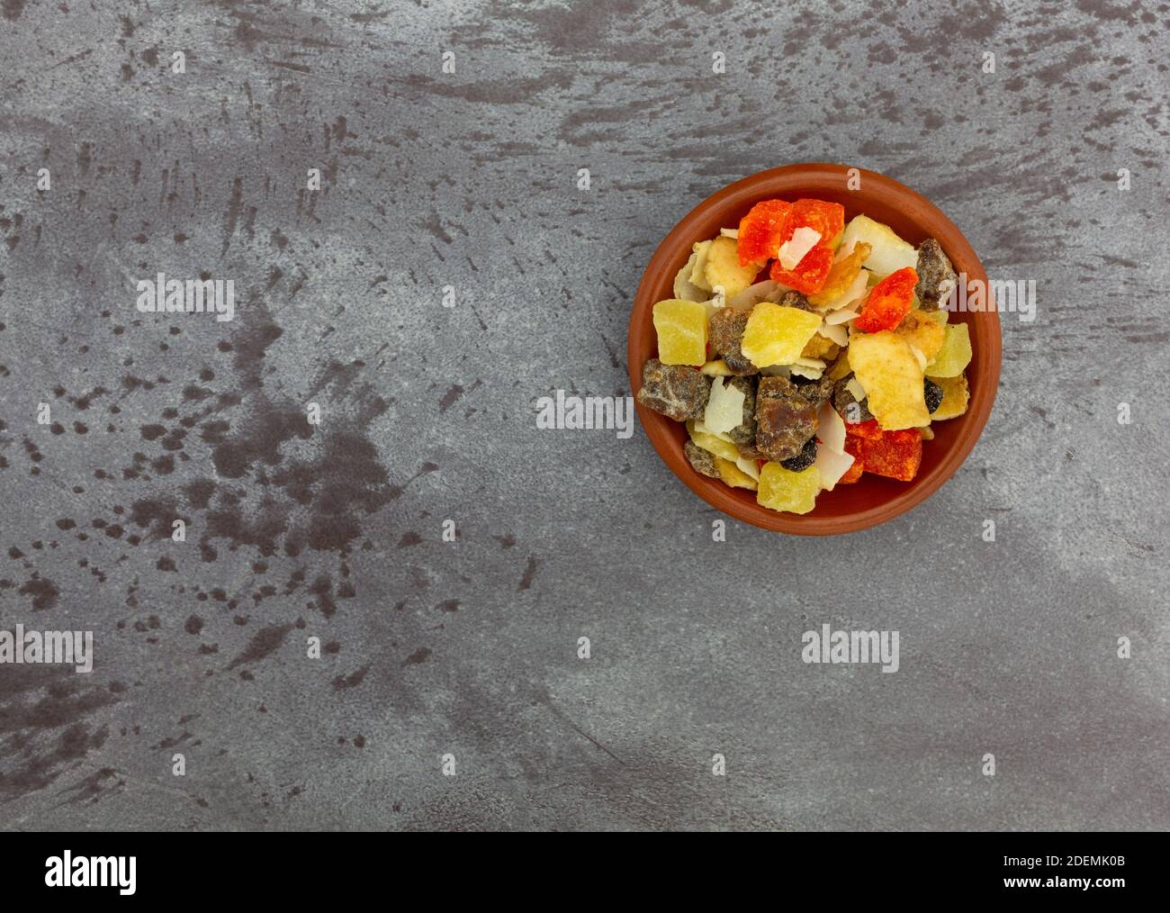Top view of a small bowl filled with several varieties of dried fruit ...
