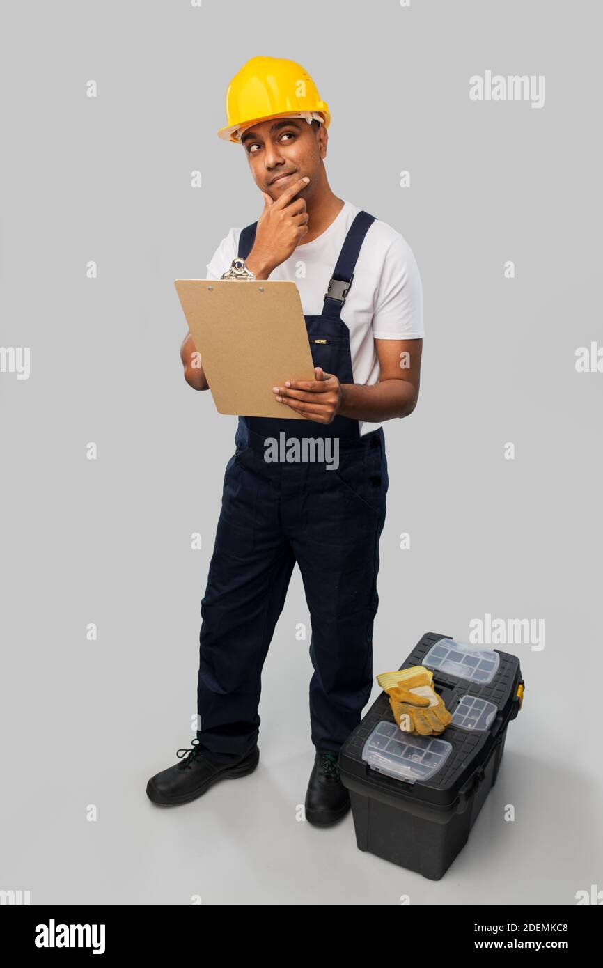 builder with clipboard and tool box thinking Stock Photo - Alamy