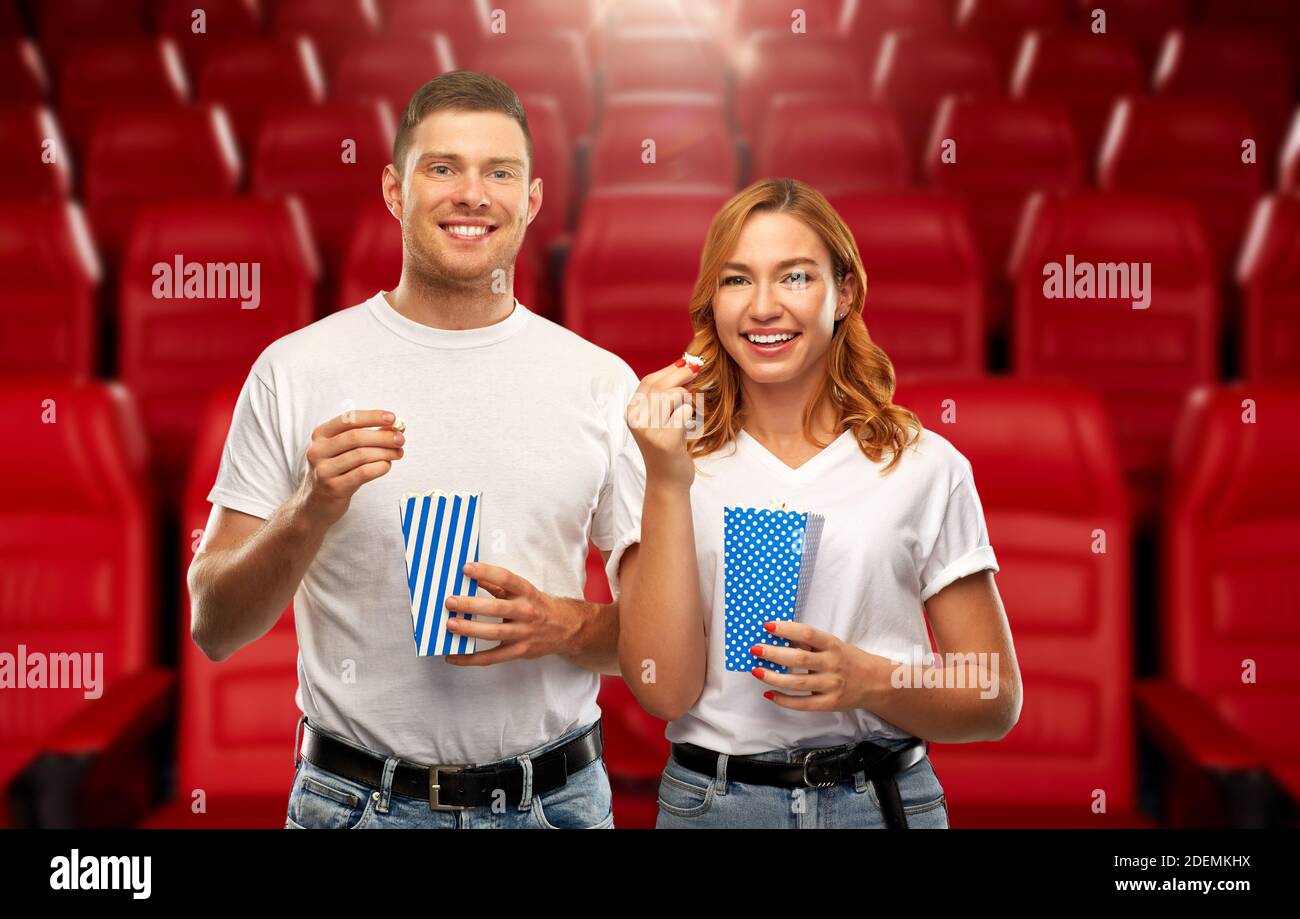 happy couple eating popcorn at movie theatre Stock Photo - Alamy