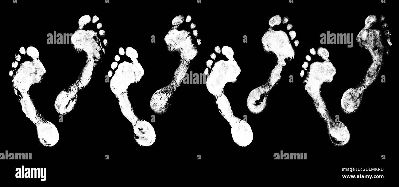 White human footprints set on black background isolated closeup ...