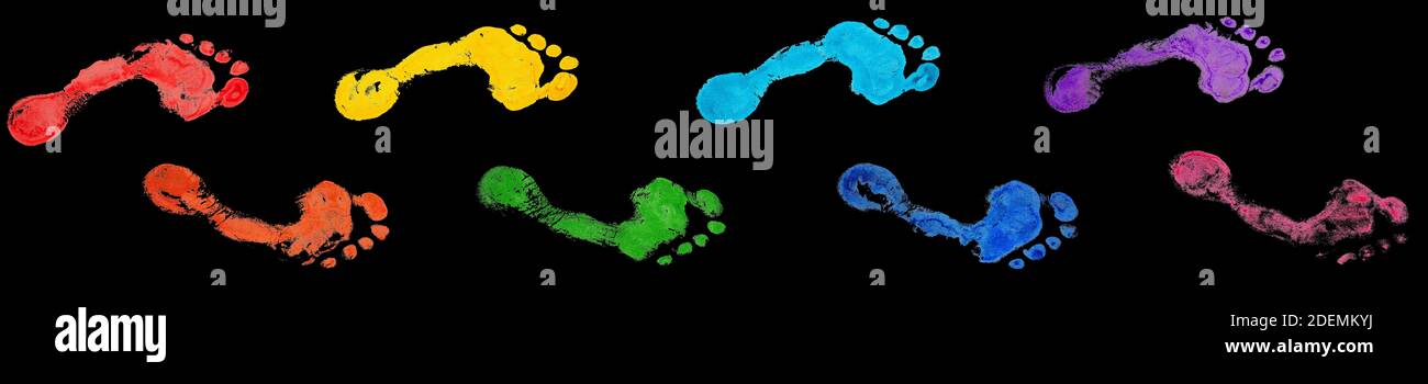Rainbow color human footprints way black background isolated, colorful ...