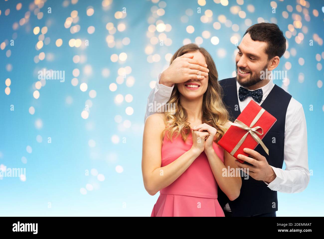 happy man giving woman surprise present Stock Photo - Alamy