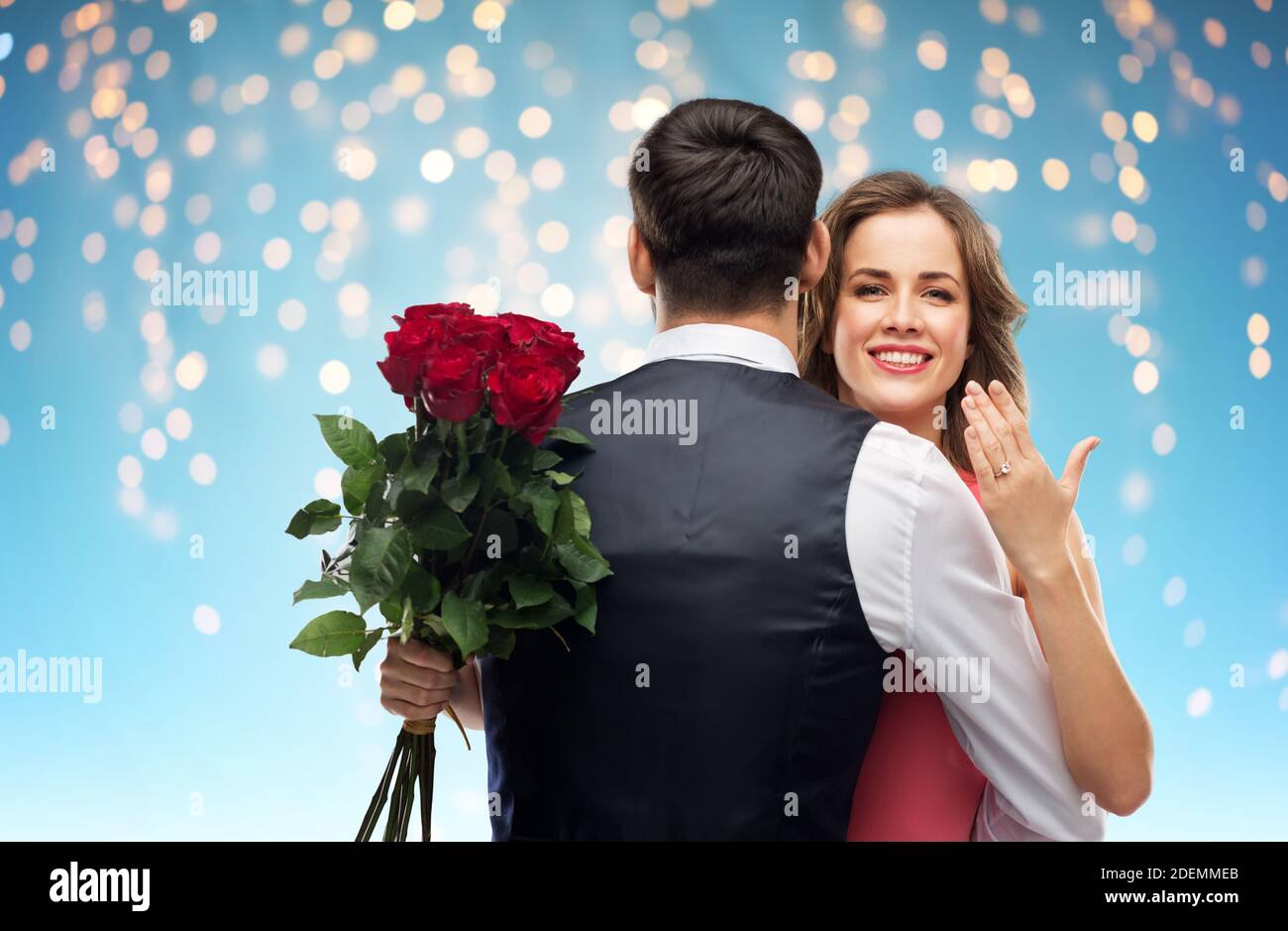 woman with engagement ring and roses hugging man Stock Photo - Alamy