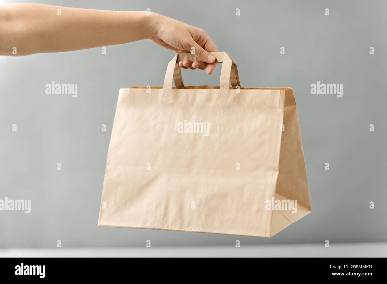 hand holding takeaway food in paper bag with lunch Stock Photo - Alamy