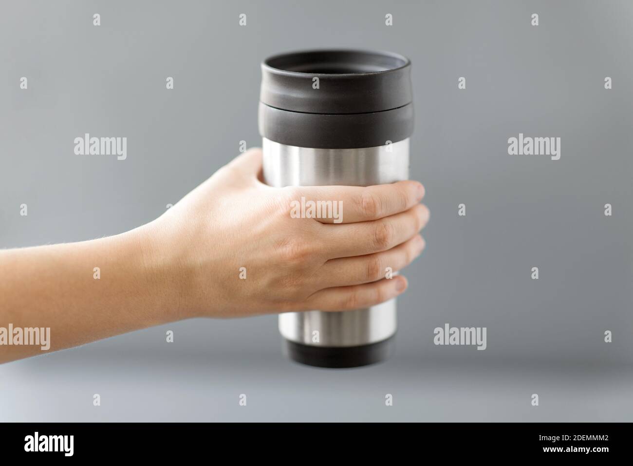 hand holding tumbler mug or thermo cup Stock Photo - Alamy