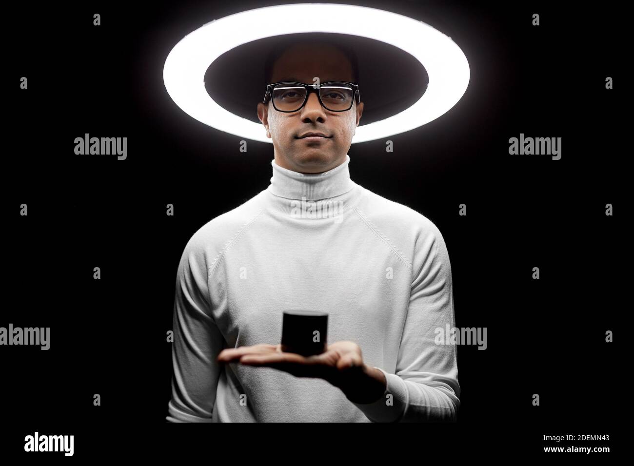 man in glasses with smart speaker under lamp Stock Photo - Alamy