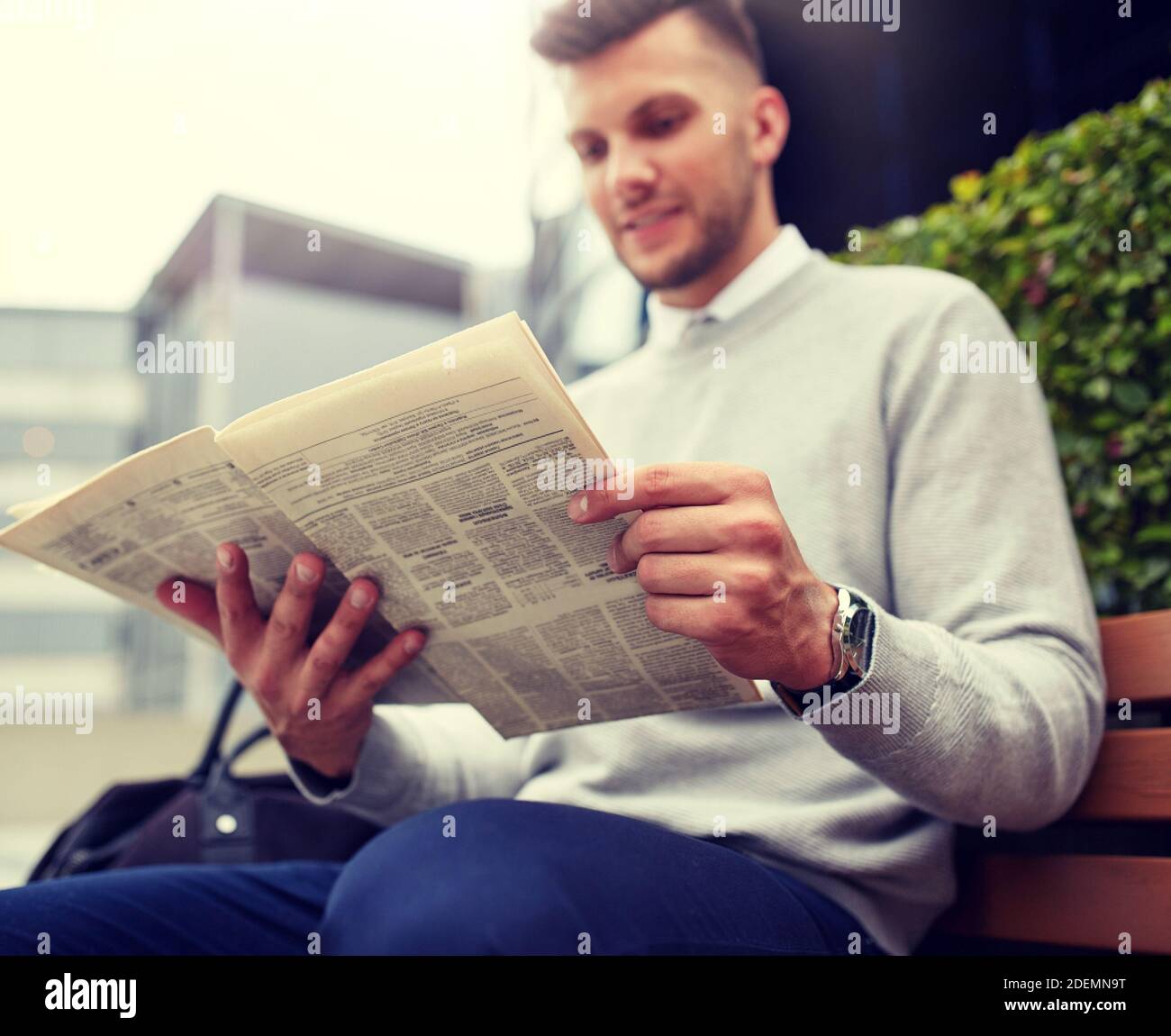 Man on bench reading newspaper hi-res stock photography and images - Alamy